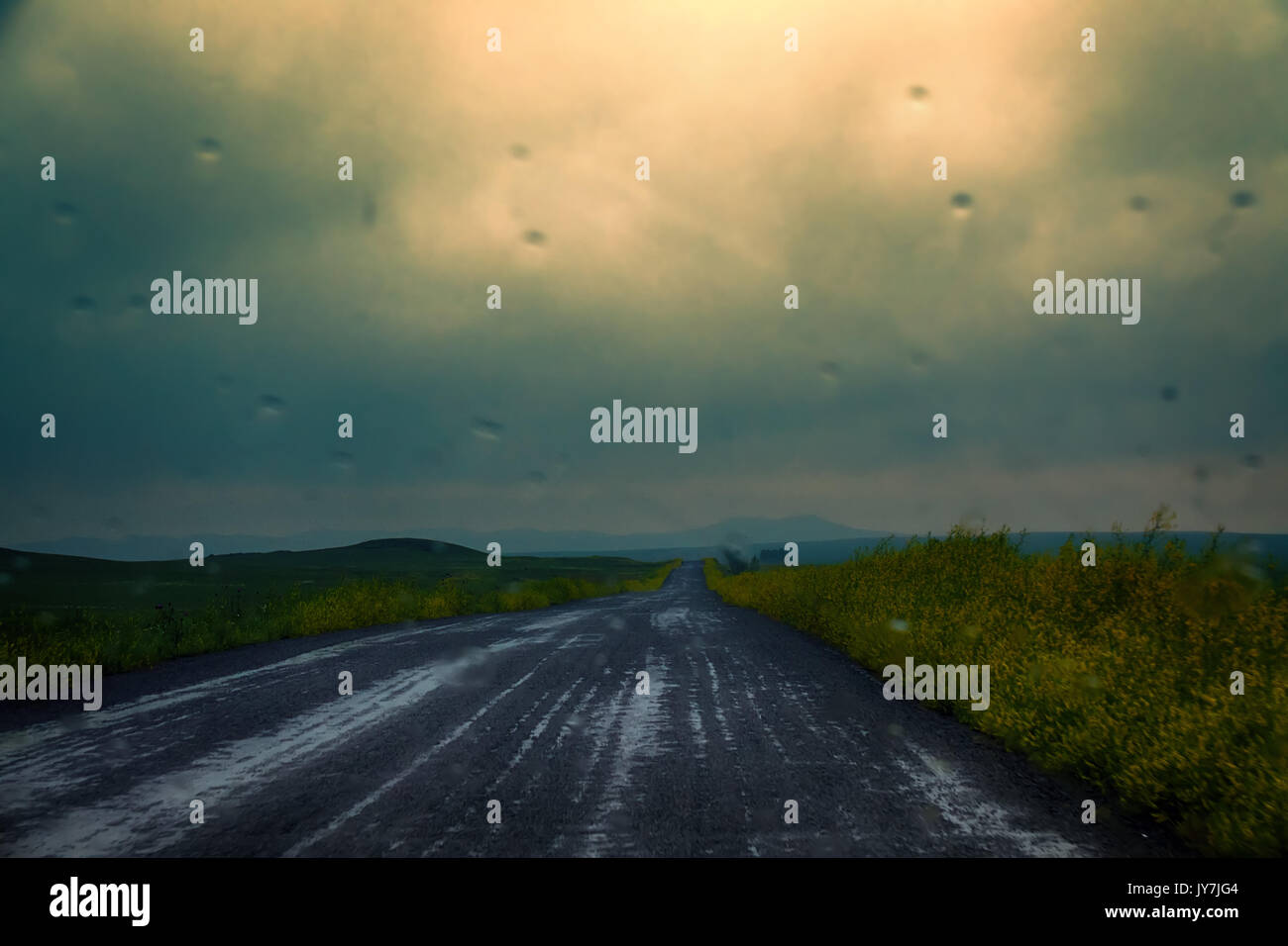 summer shower in desert a highway goes beyond horizon Stock Photo - Alamy