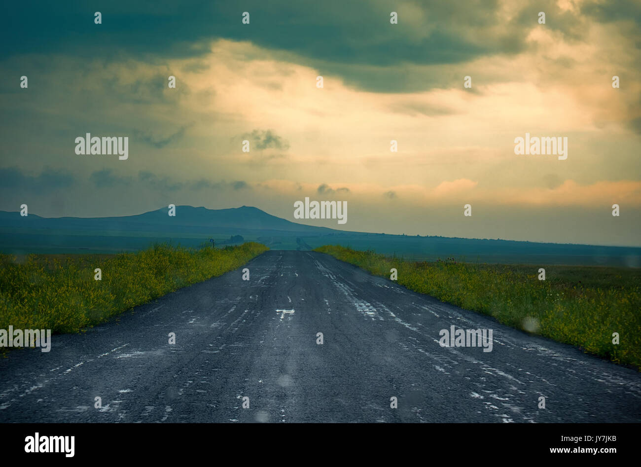 summer shower in desert a highway goes beyond horizon Stock Photo - Alamy