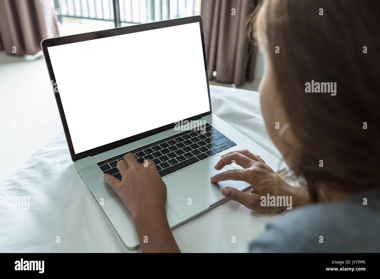 woman typing laptop keyboard white screen on bed inside room Stock ...