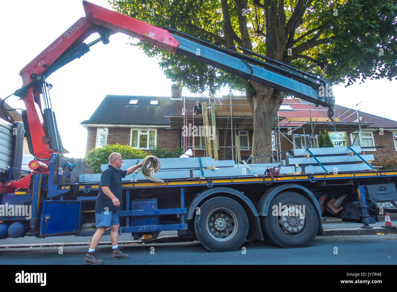Delivery of building supplies using crane on a lorry Stock Photo - Alamy