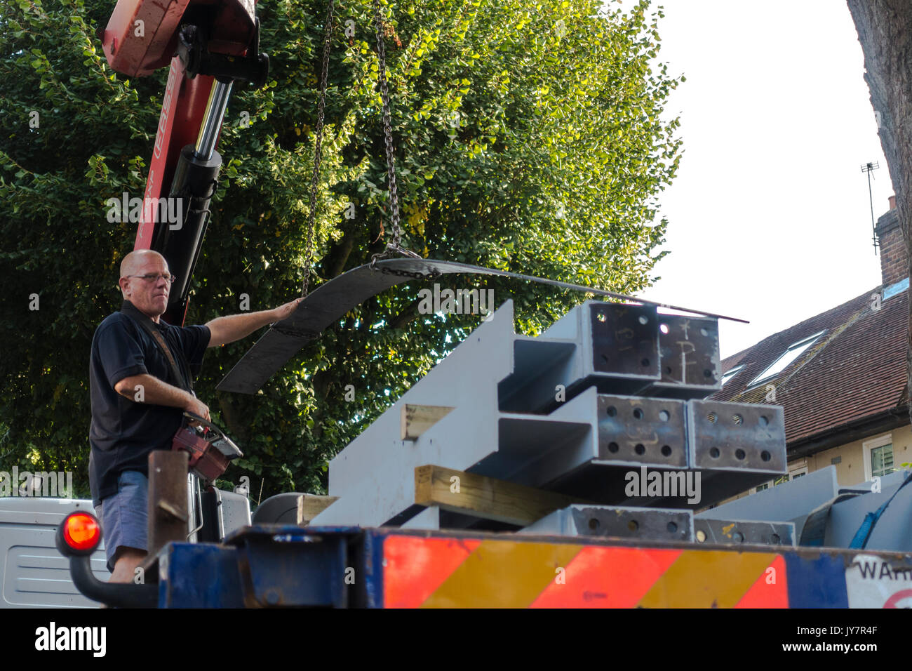 Delivery of building supplies using crane on a lorry Stock Photo - Alamy