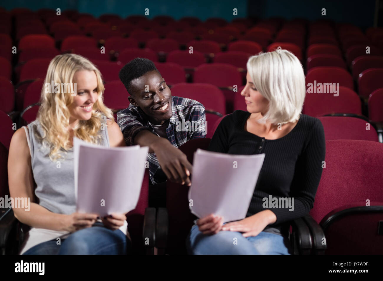 Mid-section actors reading their scripts on stage in theatre Stock ...