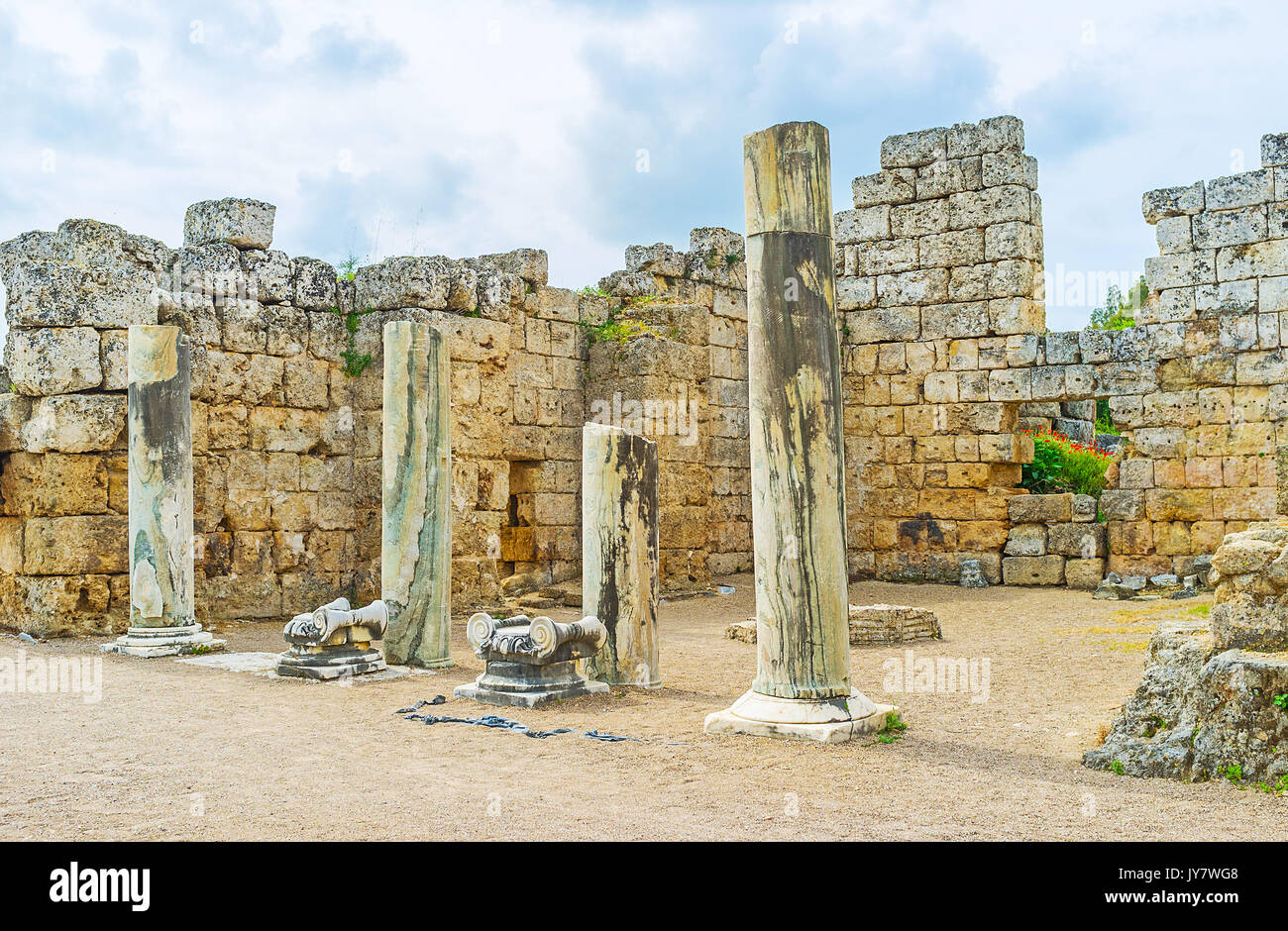 The broken columns in front of stone ruins of the ancient building in ...