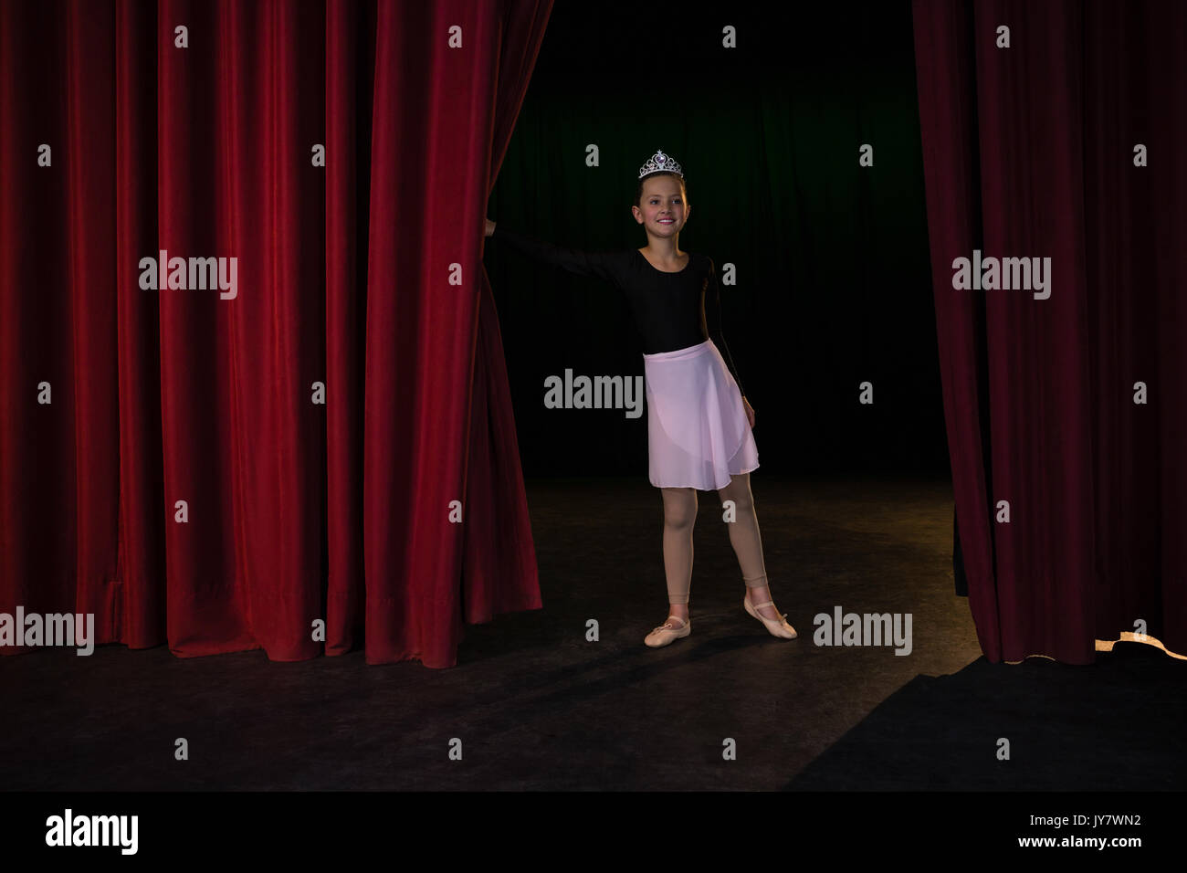 Smiling ballet dancer peeking through a stage curtain Stock Photo - Alamy