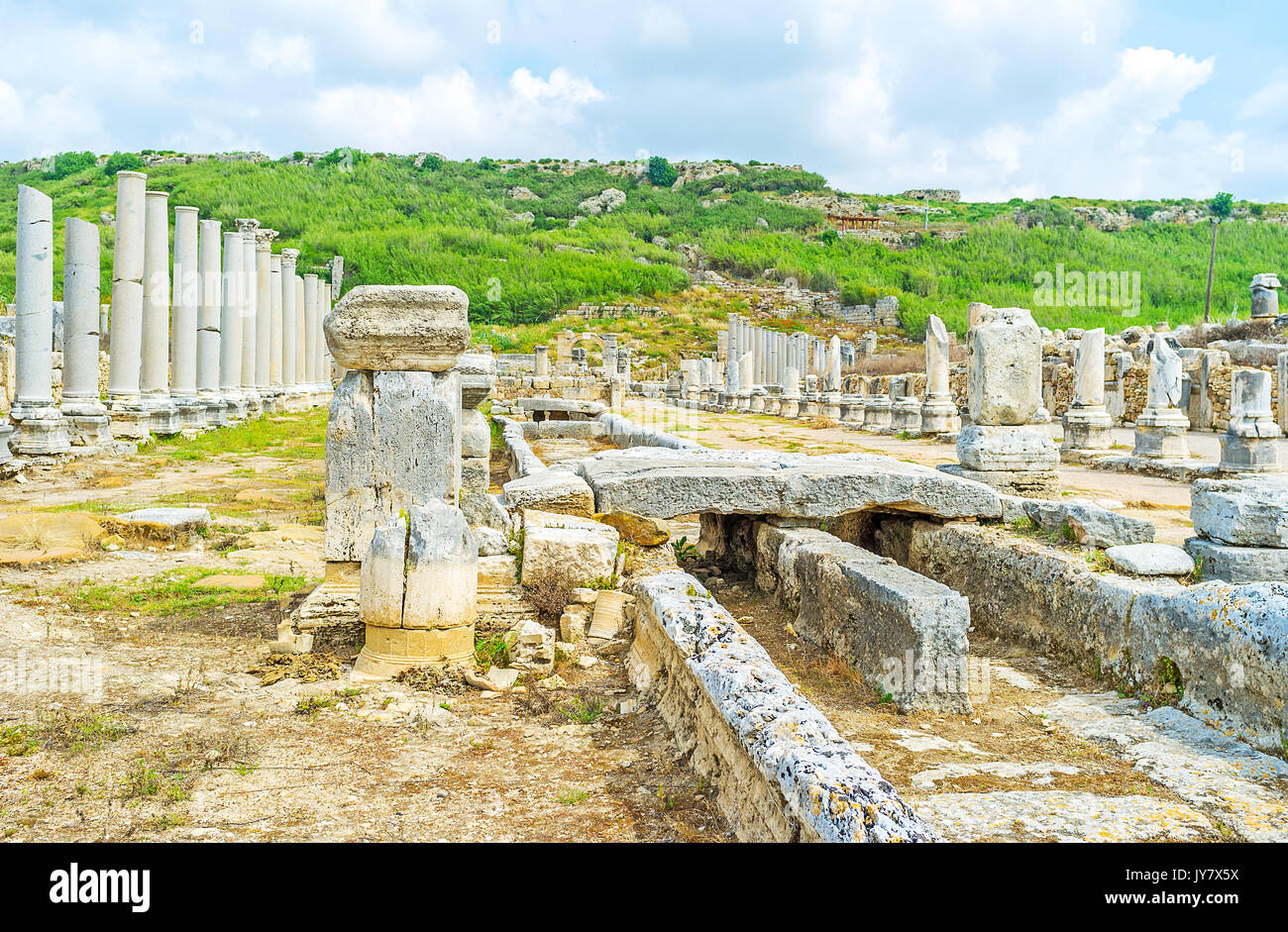 The stone canal for water with tiny bridges and preserved colonnade ...