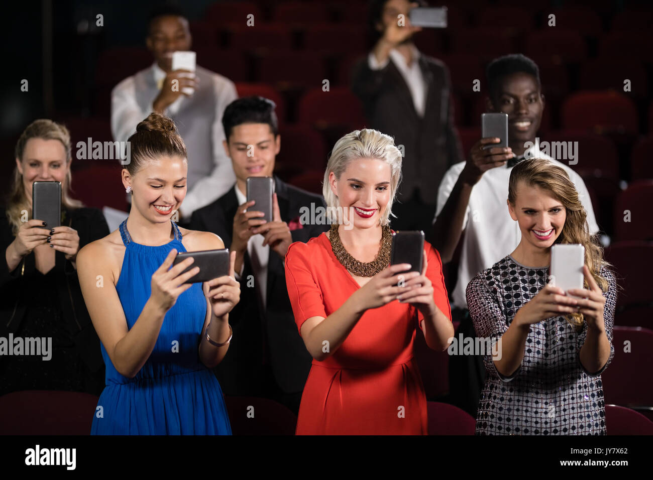 Group of people clicking photographs in movie theatre Stock Photo - Alamy