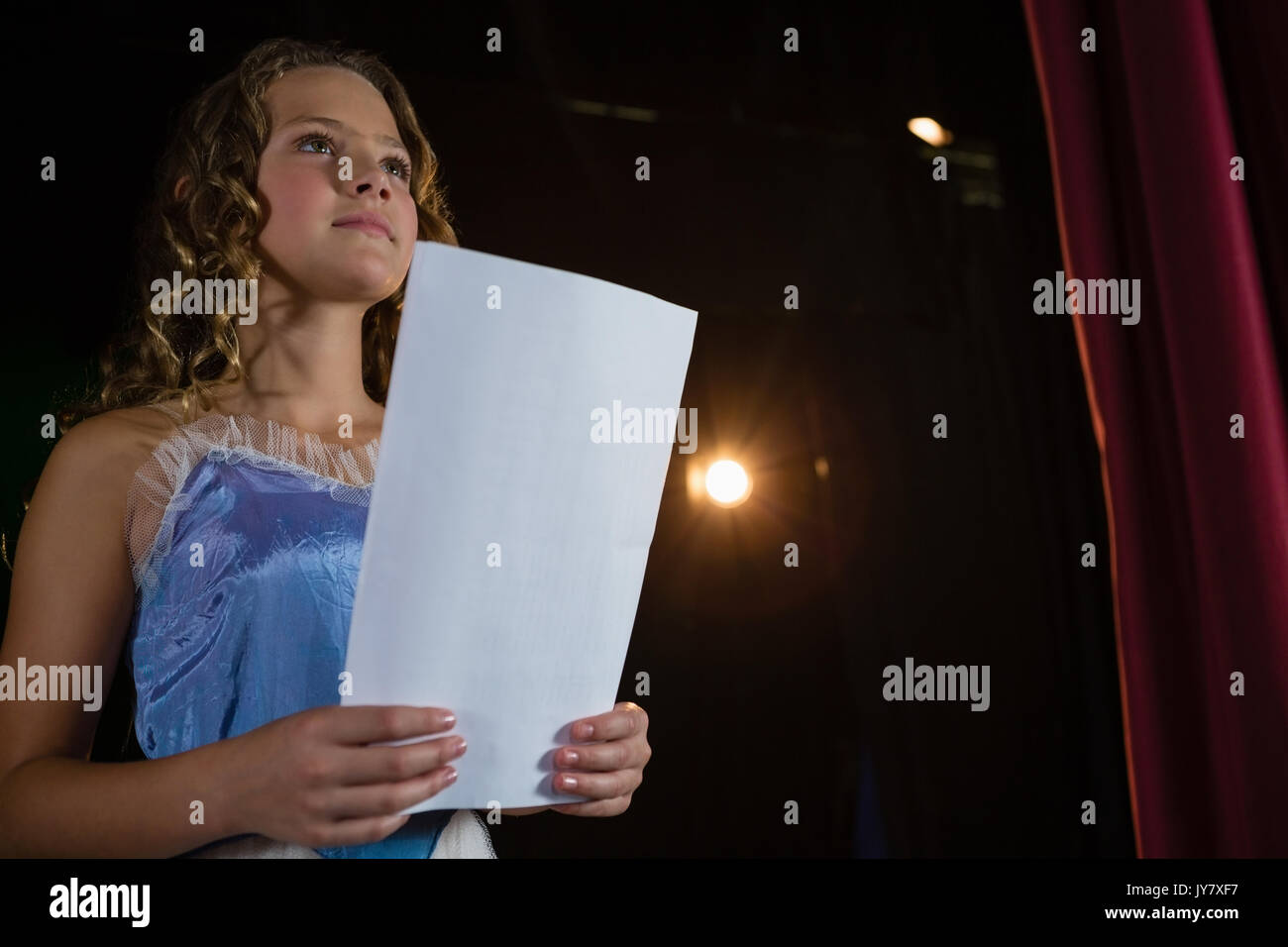 Female artist reading her scripts on stage in theatre Stock Photo - Alamy