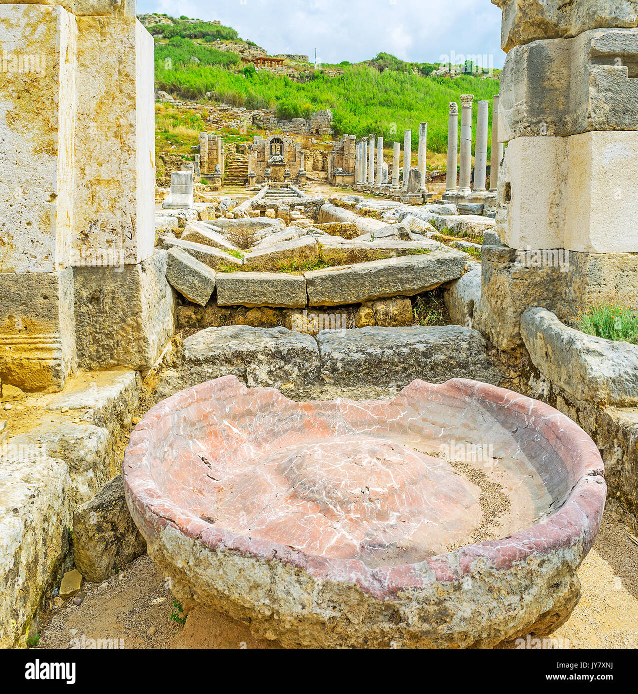 The view on ruined water canal through the Apollonius Arch of Perge ...