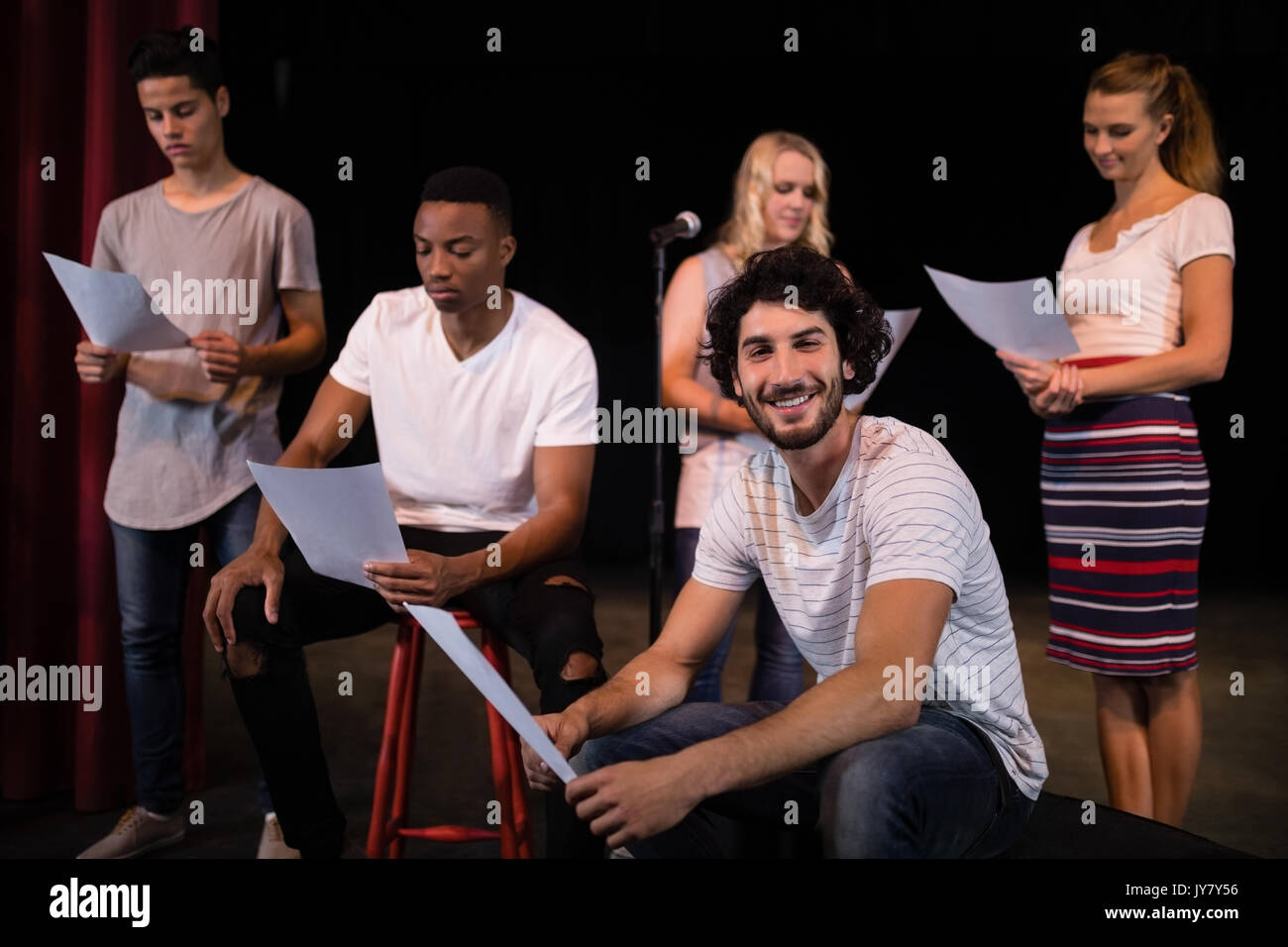 Actors reading their scripts on stage in theatre Stock Photo - Alamy