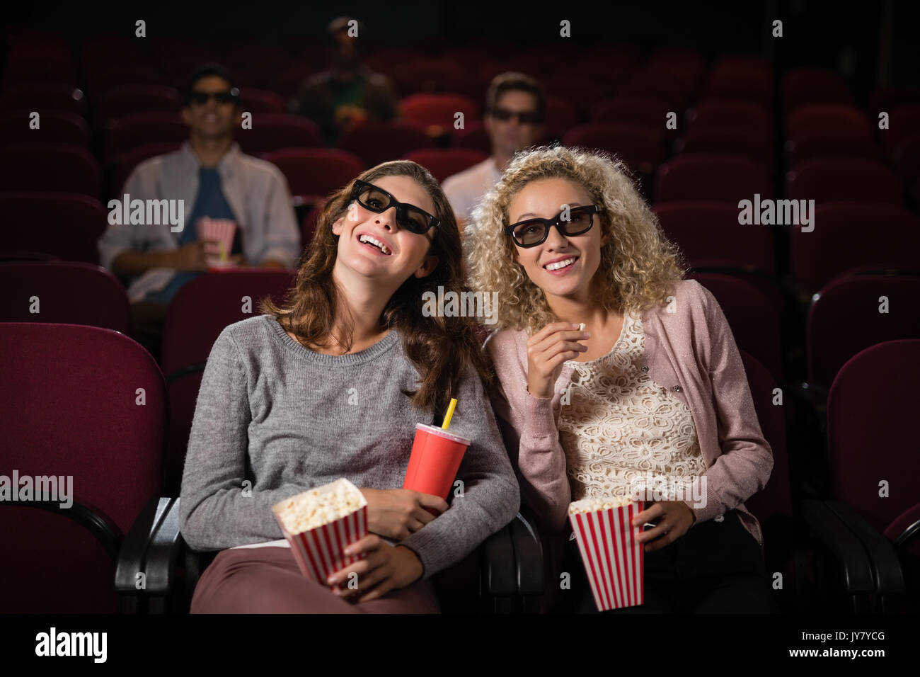 Female friends watching movie hi-res stock photography and images - Alamy