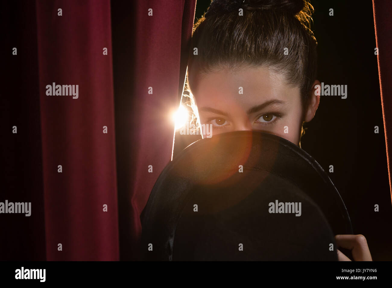 Happy ballet dancer with hat peeking through a stage curtain Stock ...