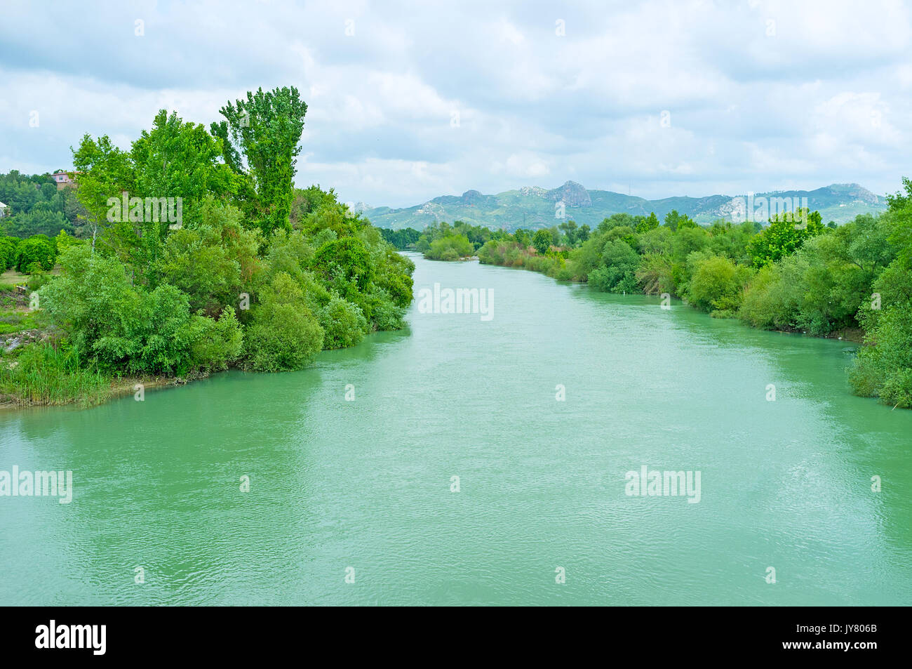 The lush greenery on the banks of fast Eurymedon river, Aspendos ...