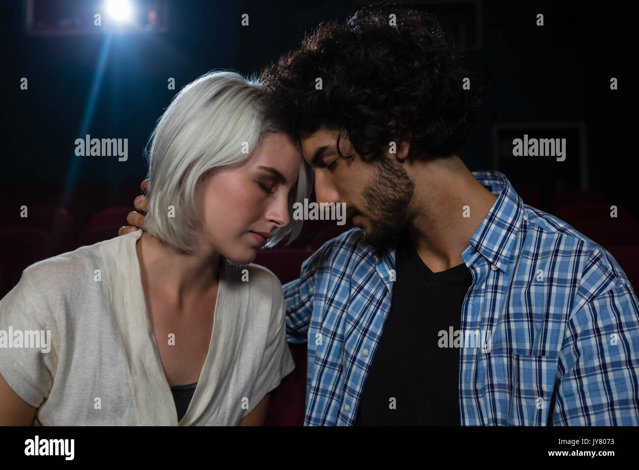 Couple having romantic moment in a movie theater Stock Photo - Alamy