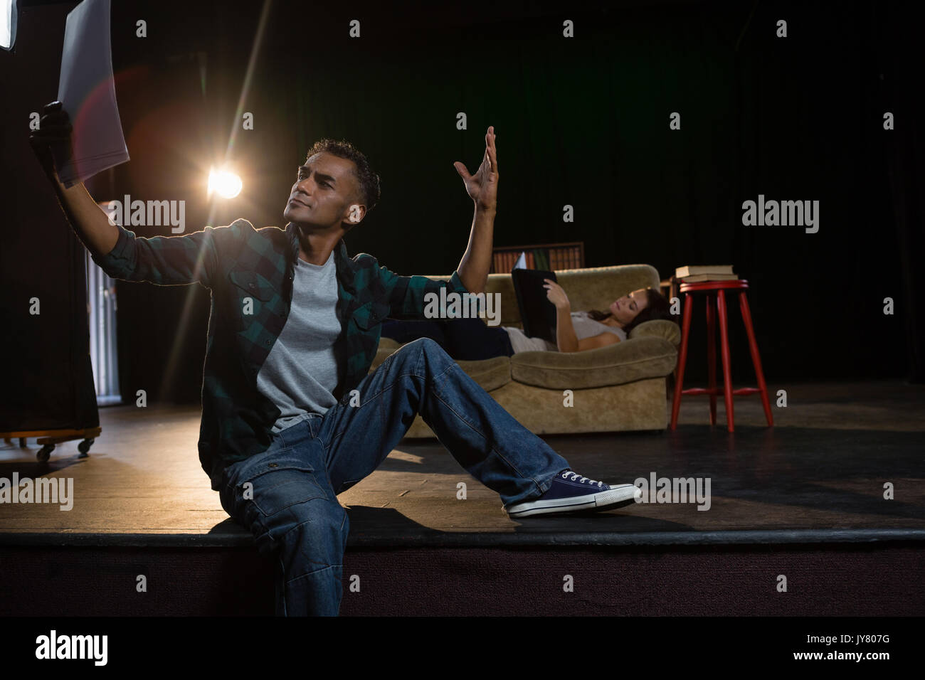 Actors reading their scripts on stage in theatre Stock Photo - Alamy