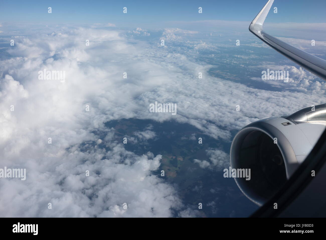 Airplane window view. View of clouds through airplane window. Above the ...