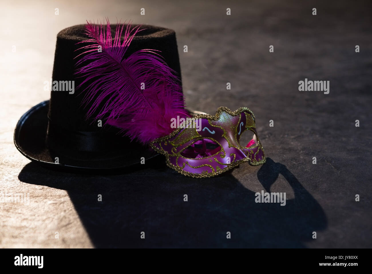 Masquerade masks and hat on stage Stock Photo - Alamy
