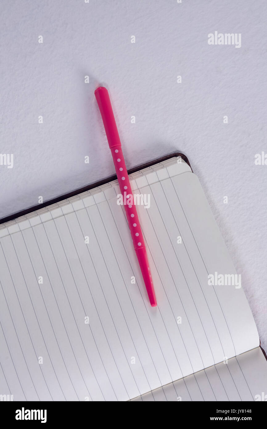 Overhead of pen on open diary on white background Stock Photo - Alamy