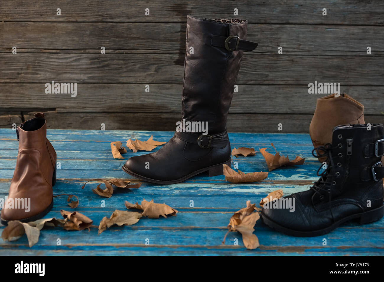 Shoes on table by wooden wall Stock Photo - Alamy