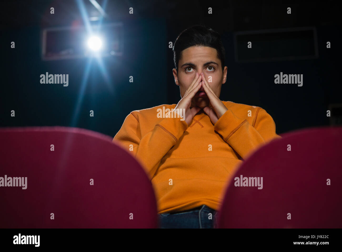 Concentrated man watching movie in theatre Stock Photo - Alamy