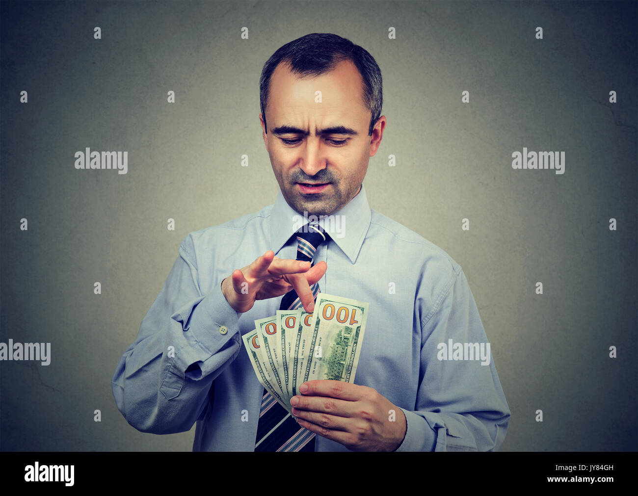 Mature business man counting money on gray background Stock Photo - Alamy