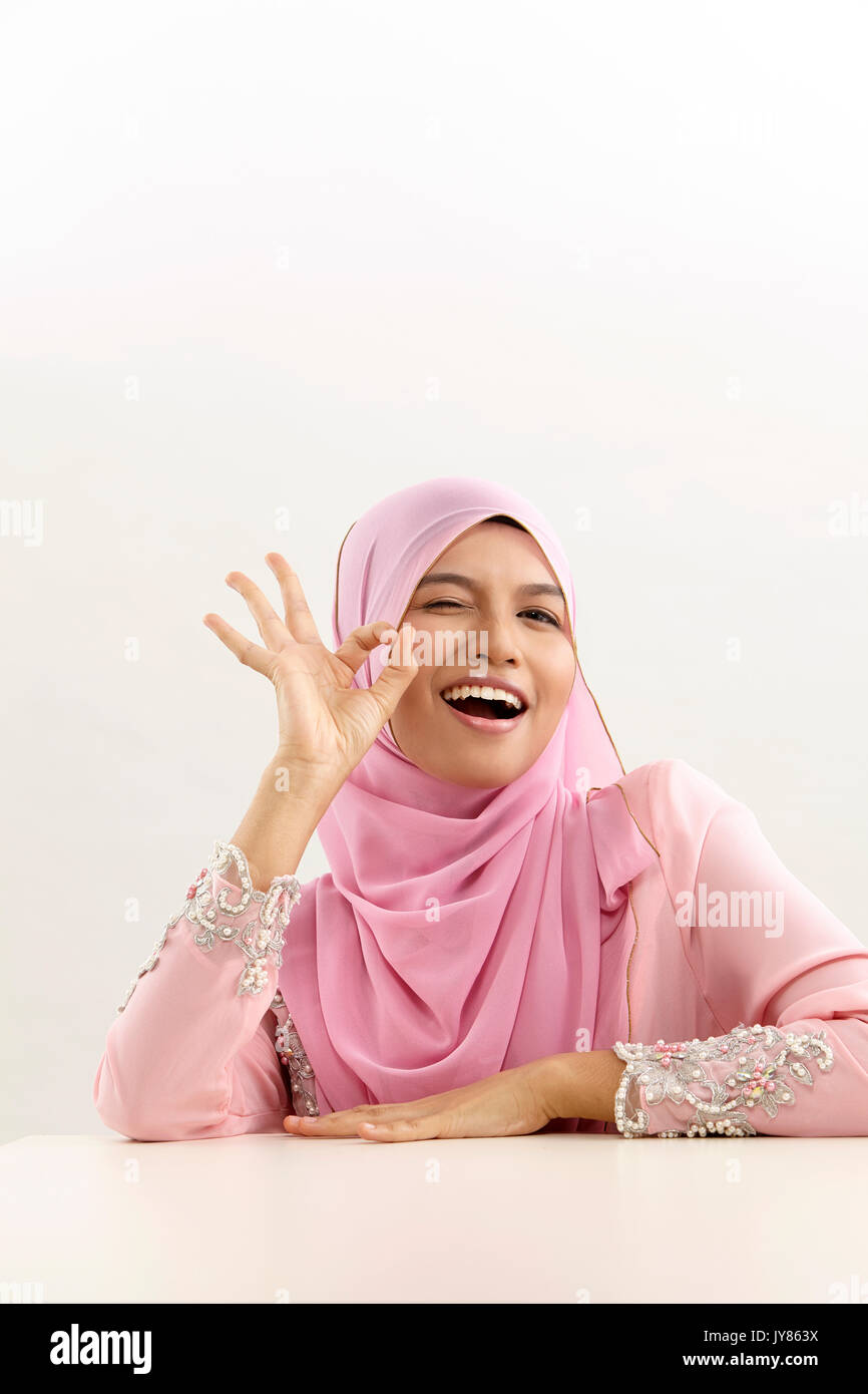 malay woman with tudung with hand sign ok Stock Photo - Alamy