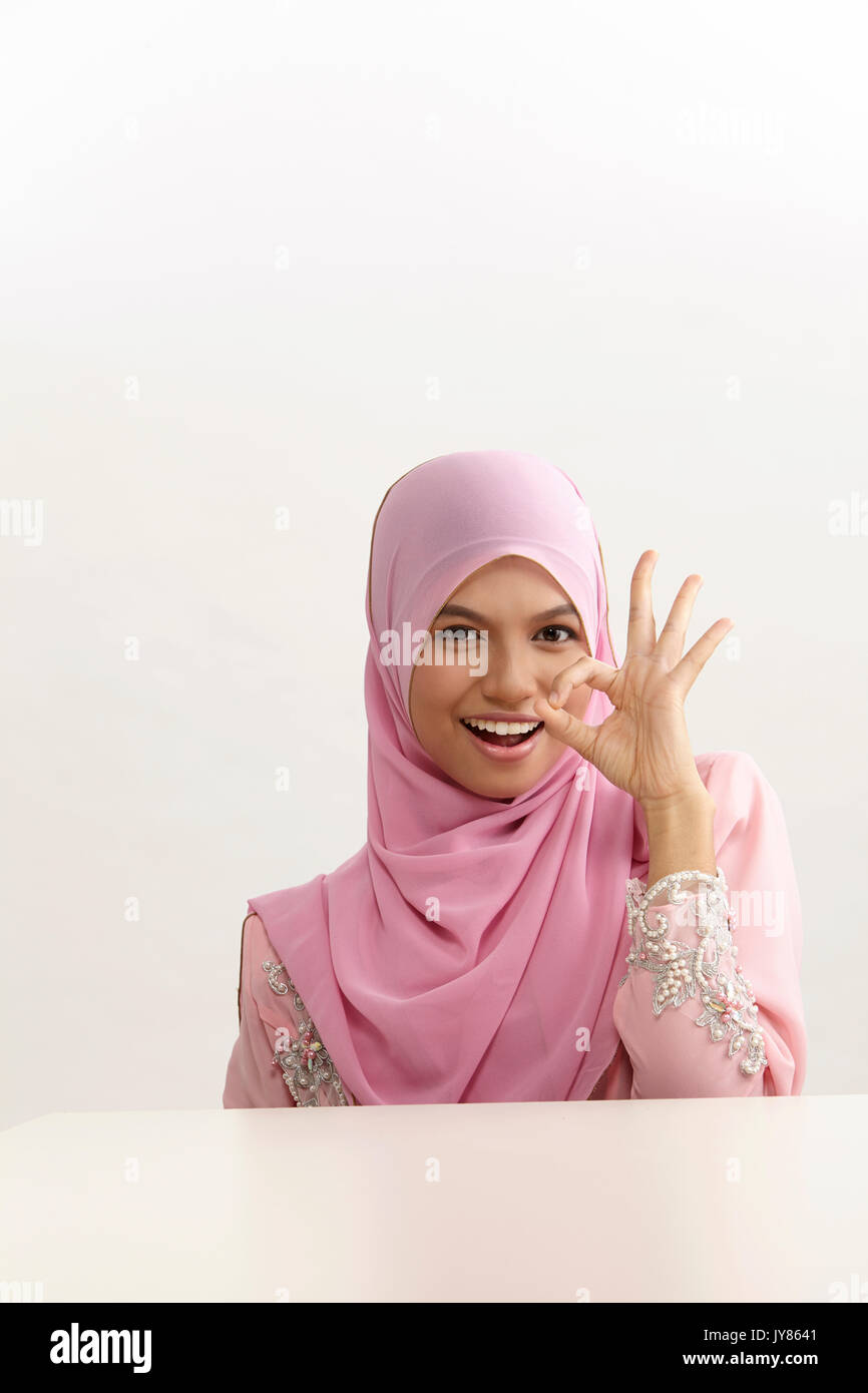 malay woman with tudung with hand sign ok Stock Photo - Alamy