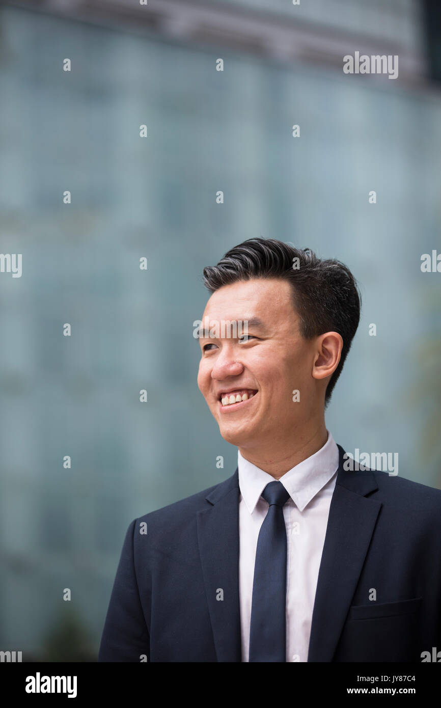 Chinese business man in modern Asian city. Portrait of an Asian ...