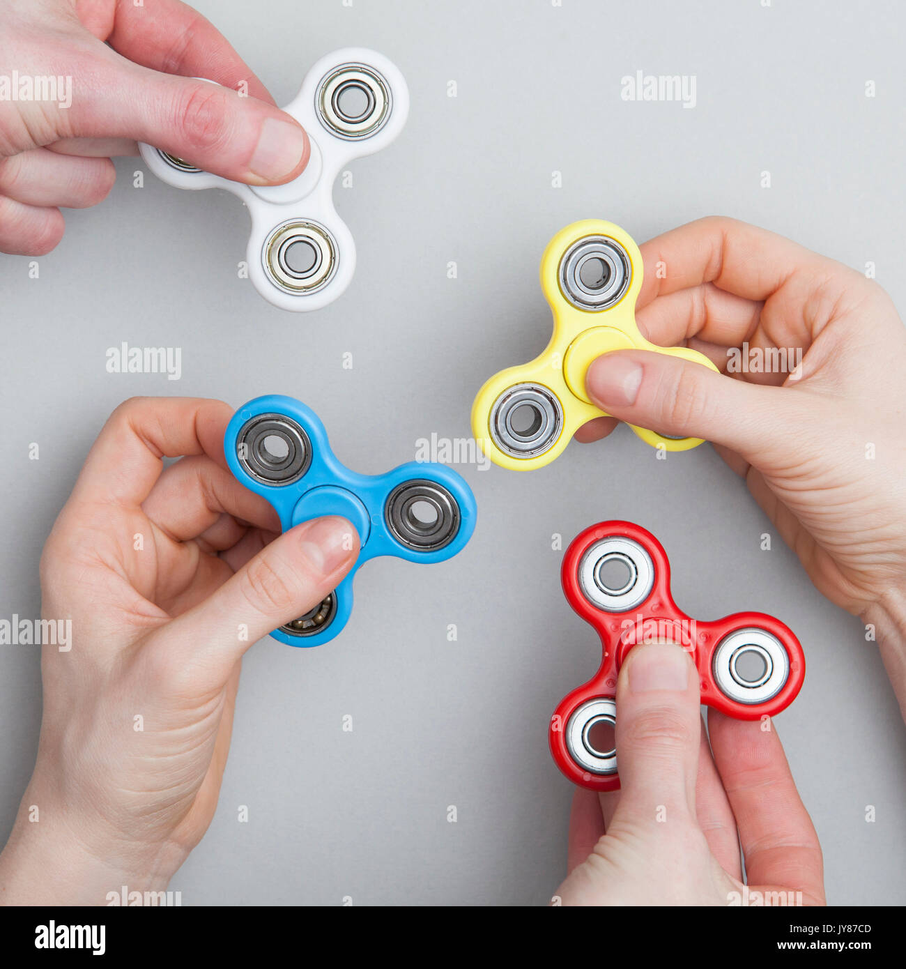 Hands holding popular fidget spinner toy Stock Photo - Alamy