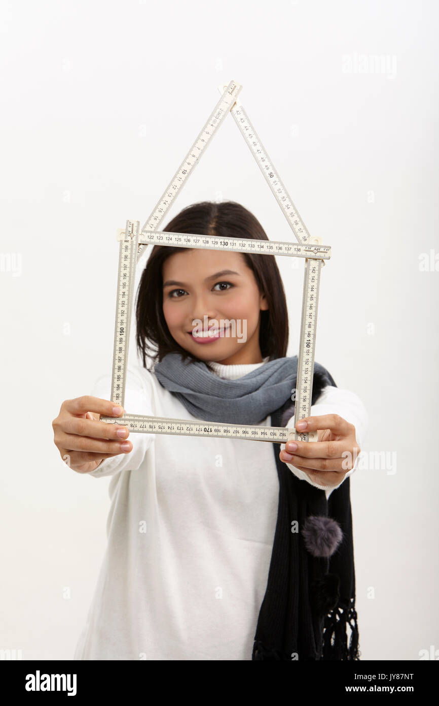 malay woman holding a folderable ruler form a house shape Stock Photo ...