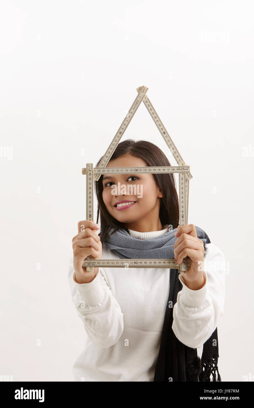 malay woman holding a folderable ruler form a house shape Stock Photo ...