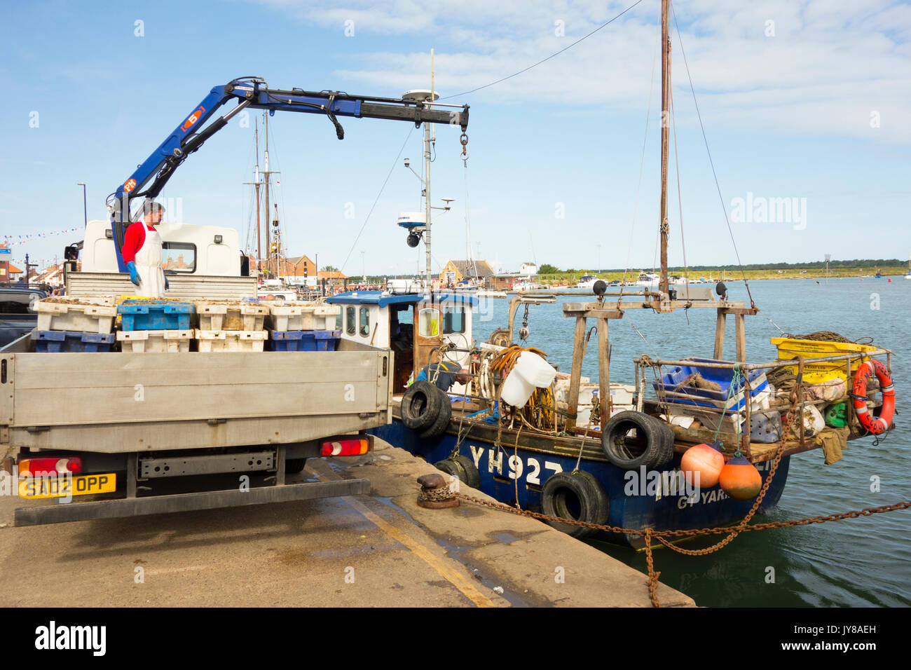 Freshly caught seafood being unloaded from a small fishing trawler on ...