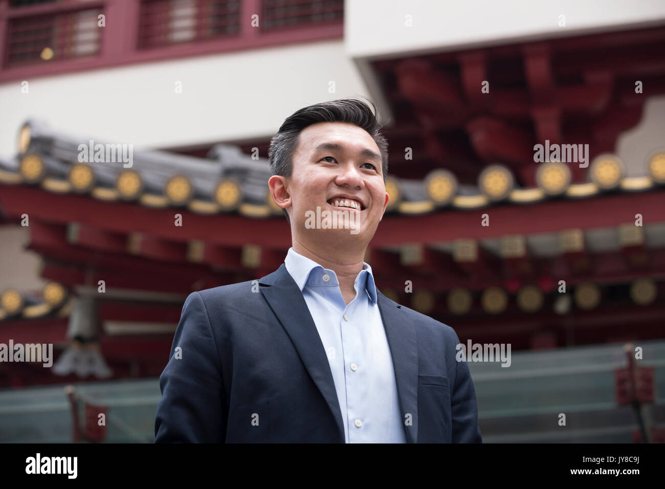 Chinese business man in Asian city. Asian businessman smiling & looking ...