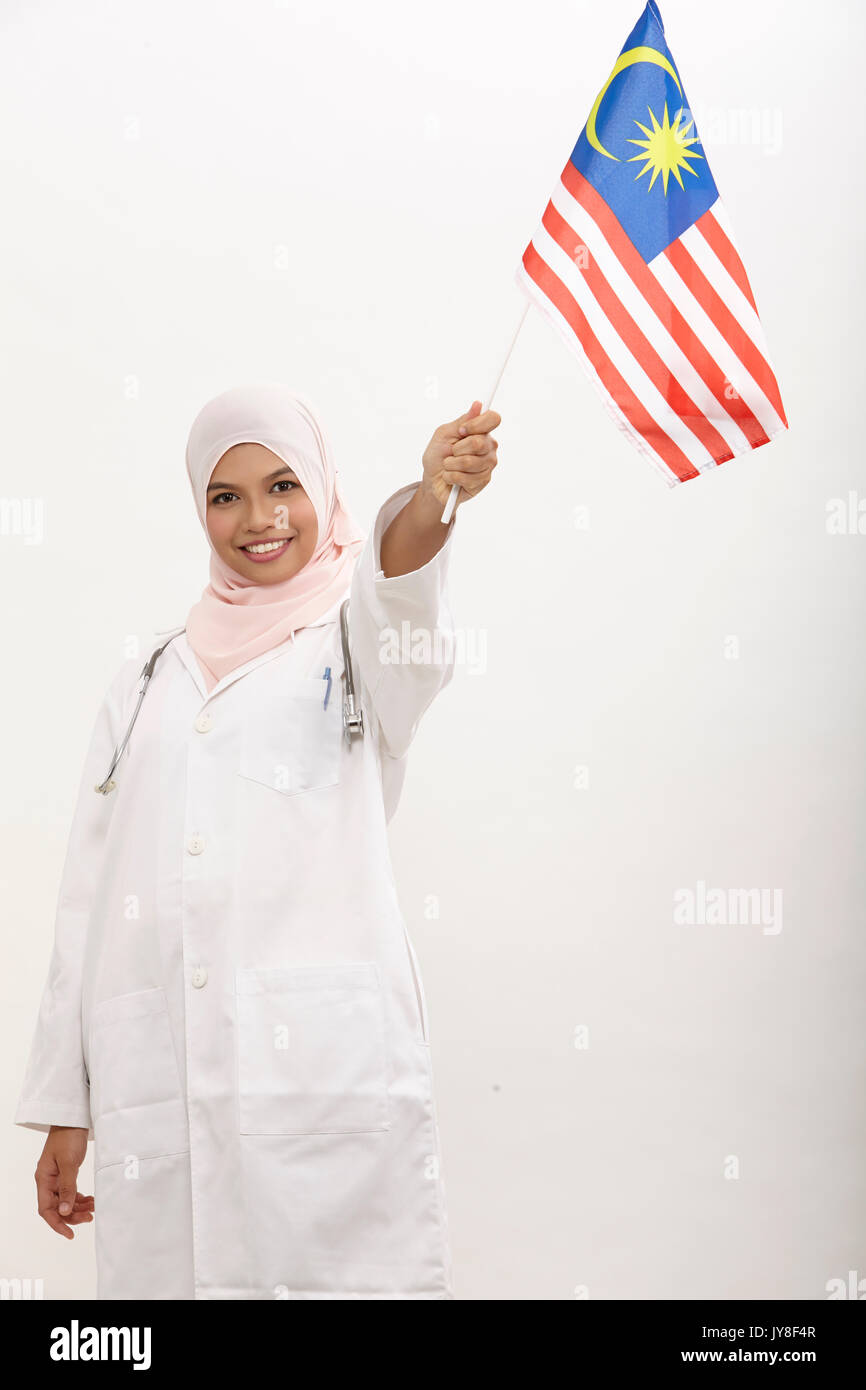 malay female doctor holding malaysia flag on the white background Stock ...