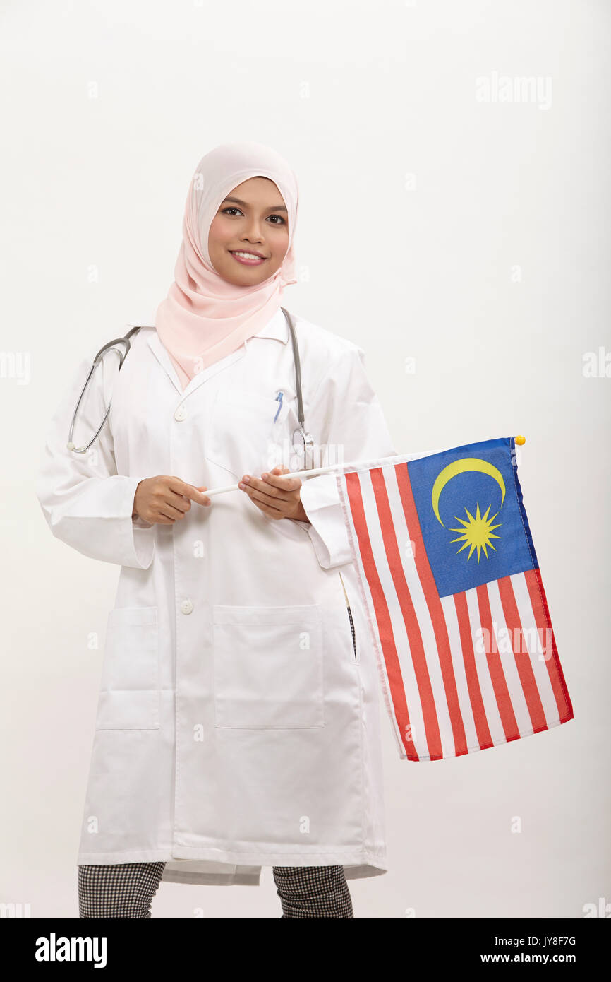 malay female doctor holding malaysia flag on the white background Stock ...