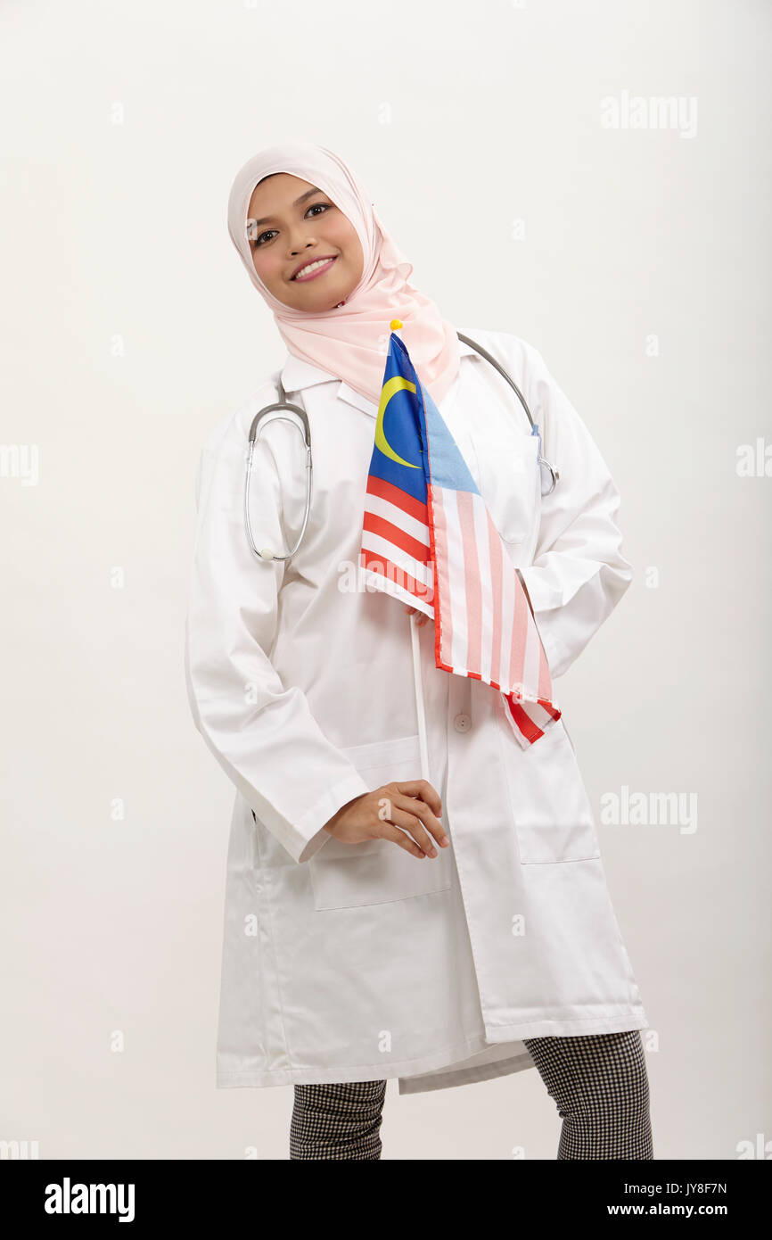 malay female doctor holding malaysia flag on the white background Stock ...