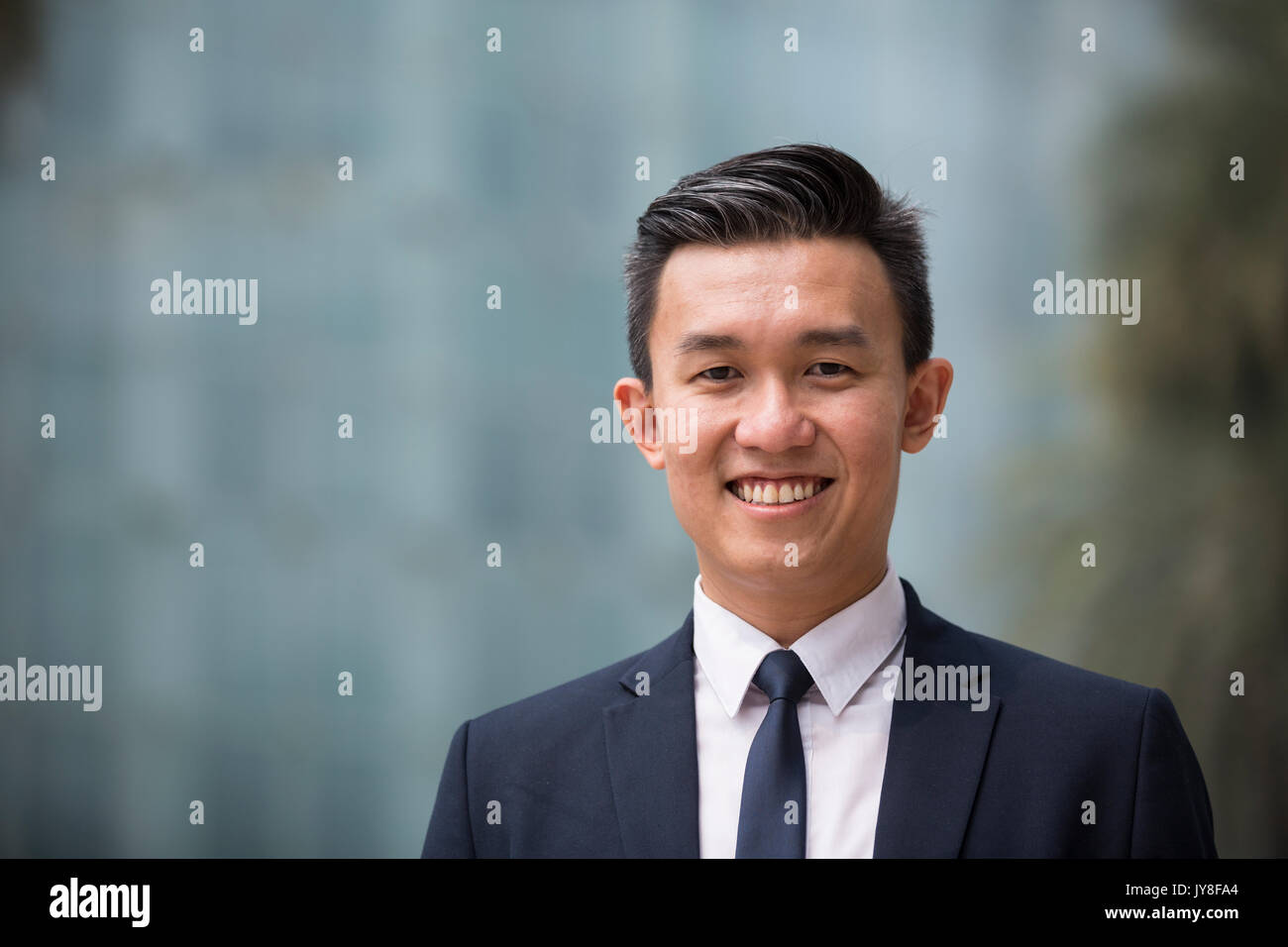 Chinese business man in modern Asian city. Portrait of an Asian ...
