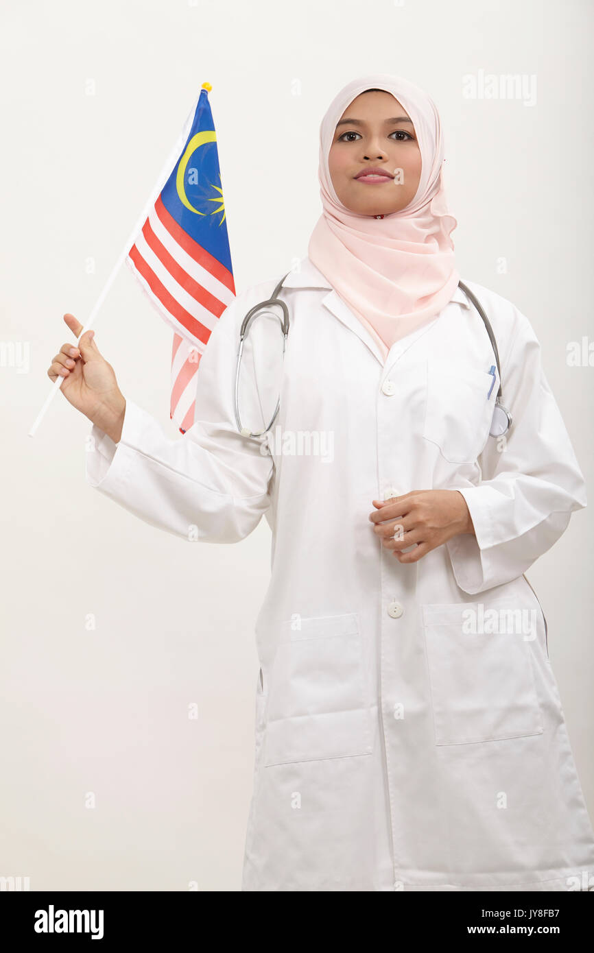 malay female doctor holding malaysia flag on the white background Stock ...