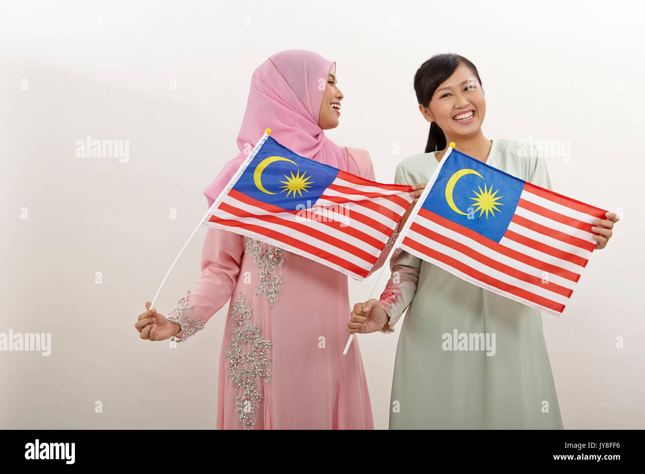 two malay women holding malaysia flag Stock Photo - Alamy