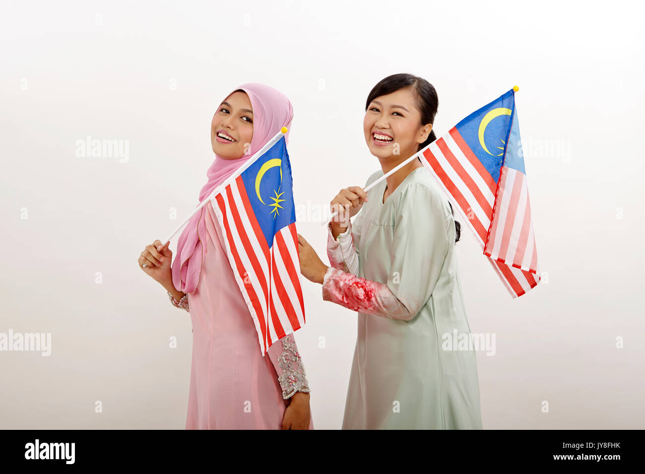 two malay women holding malaysia flag Stock Photo - Alamy