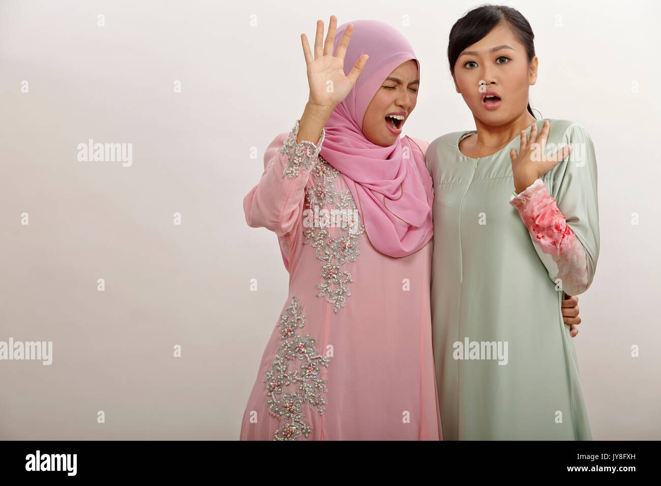 two malay women with scared expression Stock Photo - Alamy