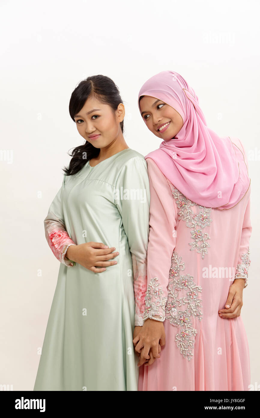 Happy two malay women on the white background Stock Photo - Alamy
