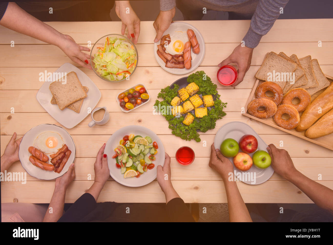 Enjoying dinner with friends. Top view of group of people having dinner ...