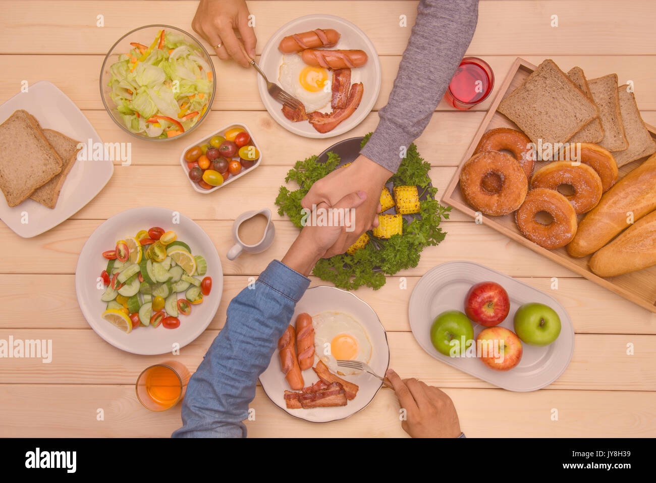 Top view of business people shaking hands agreement while having dinner ...