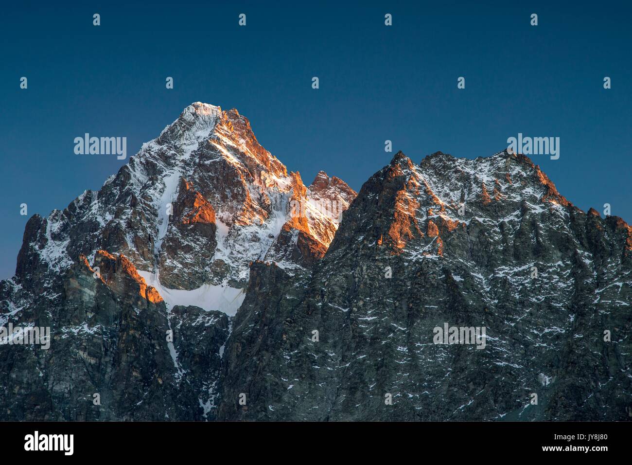 The peak of Monviso covered in snow and lighted by sunset. Monviso ...