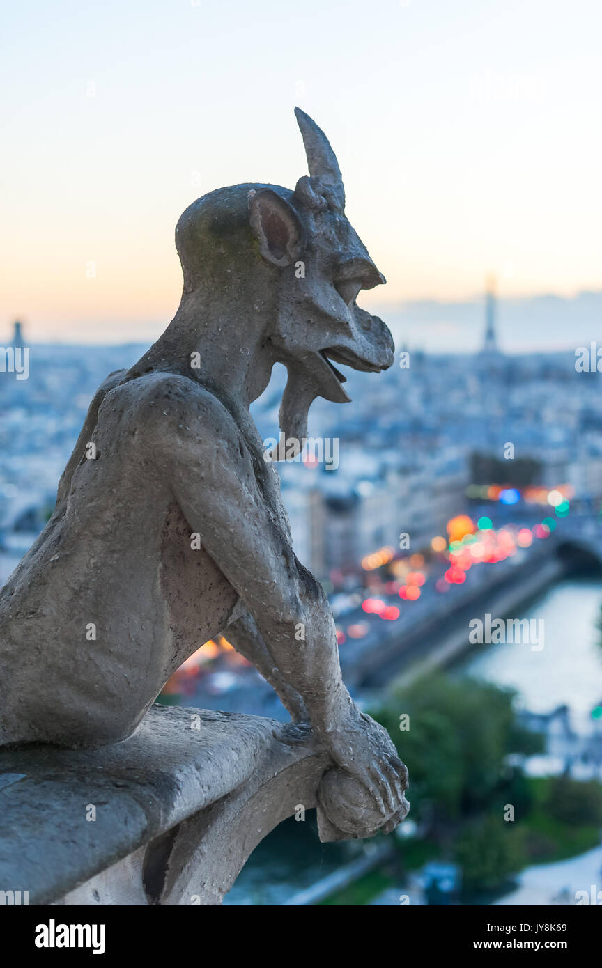 Gargoyle watching Eiffel tower and Paris at dusk Stock Photo - Alamy