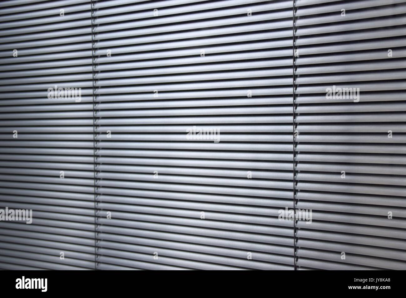 metal shutter behind an office window, blinds behind a window, window ...