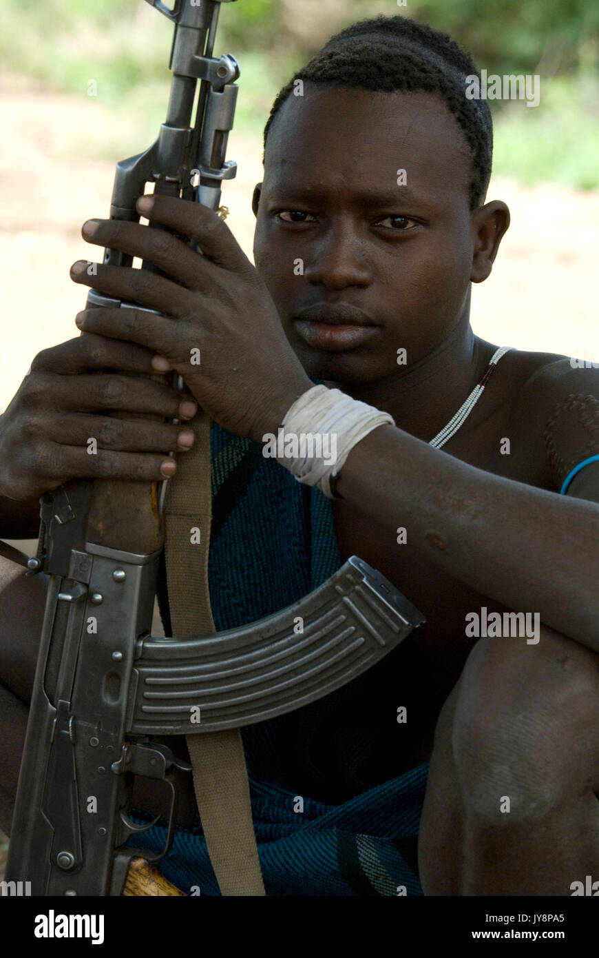 Young man with gun AK47, Mursi Tribe, Mago National Park, Lower Omo ...