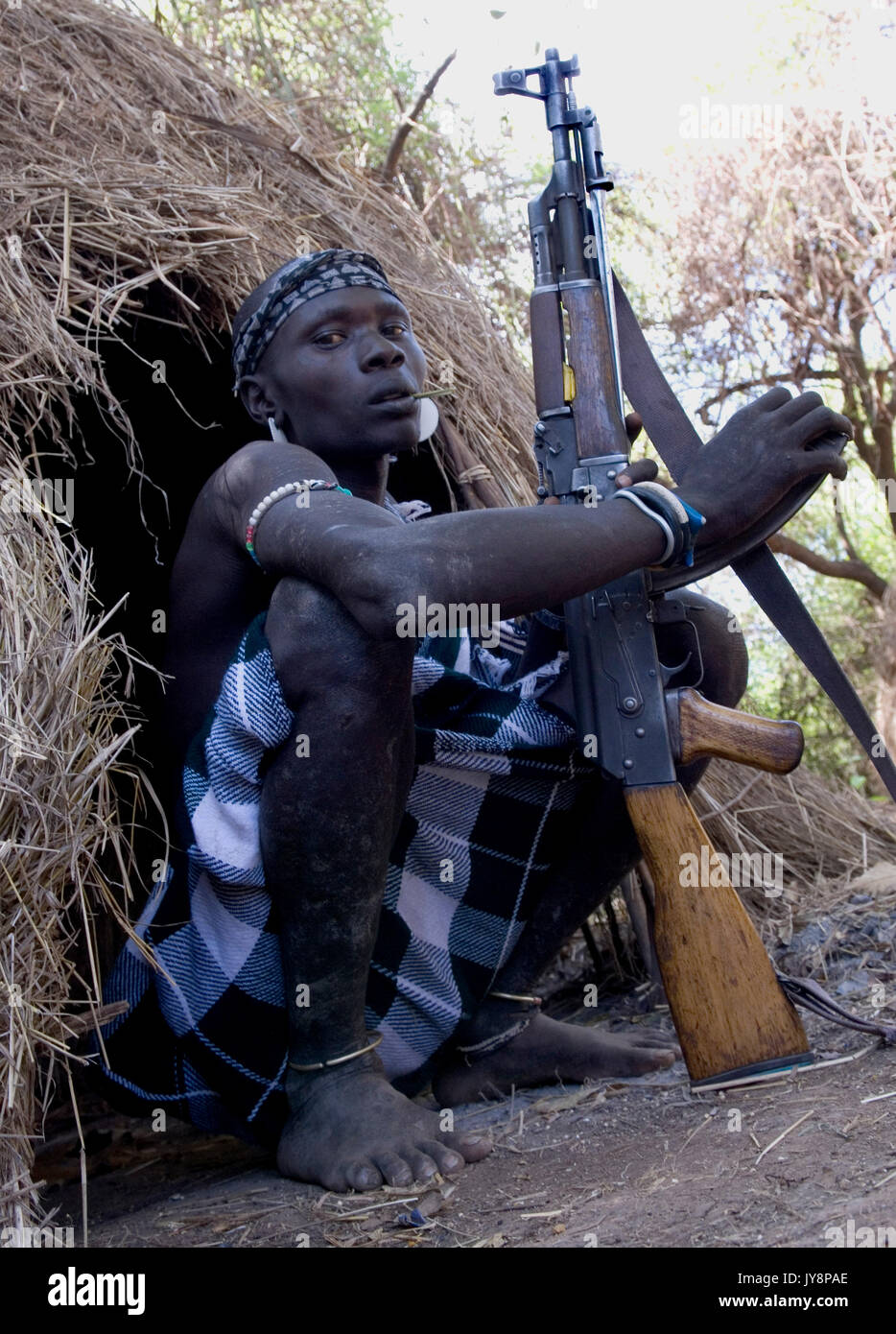 Young man with gun AK47, Mursi Tribe, Mago National Park, Lower Omo ...