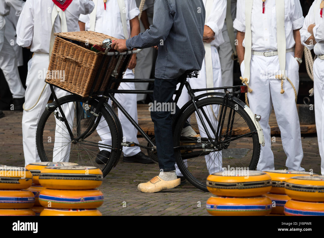 Man in clogs rides traditonal Dutch bicycle at the Edam cheese market ...