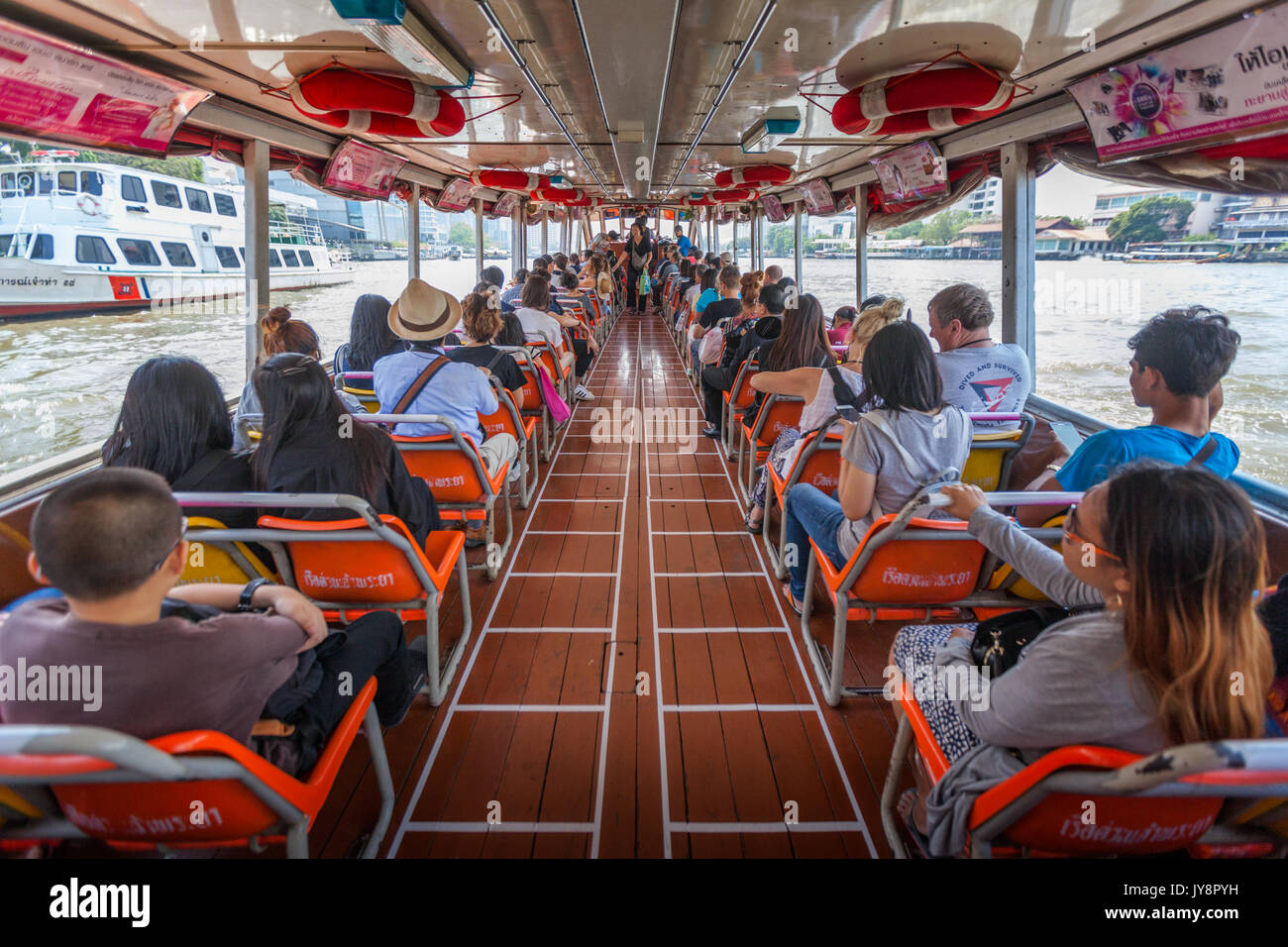 Express boat interior with sitting passengers and tourists on Chao ...